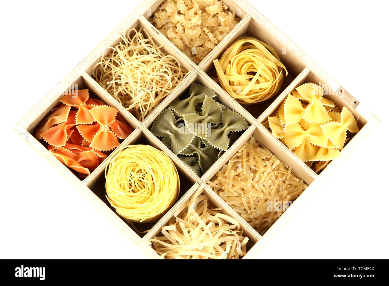 Nine types of pasta in wooden box sections close-up isolated on white ...