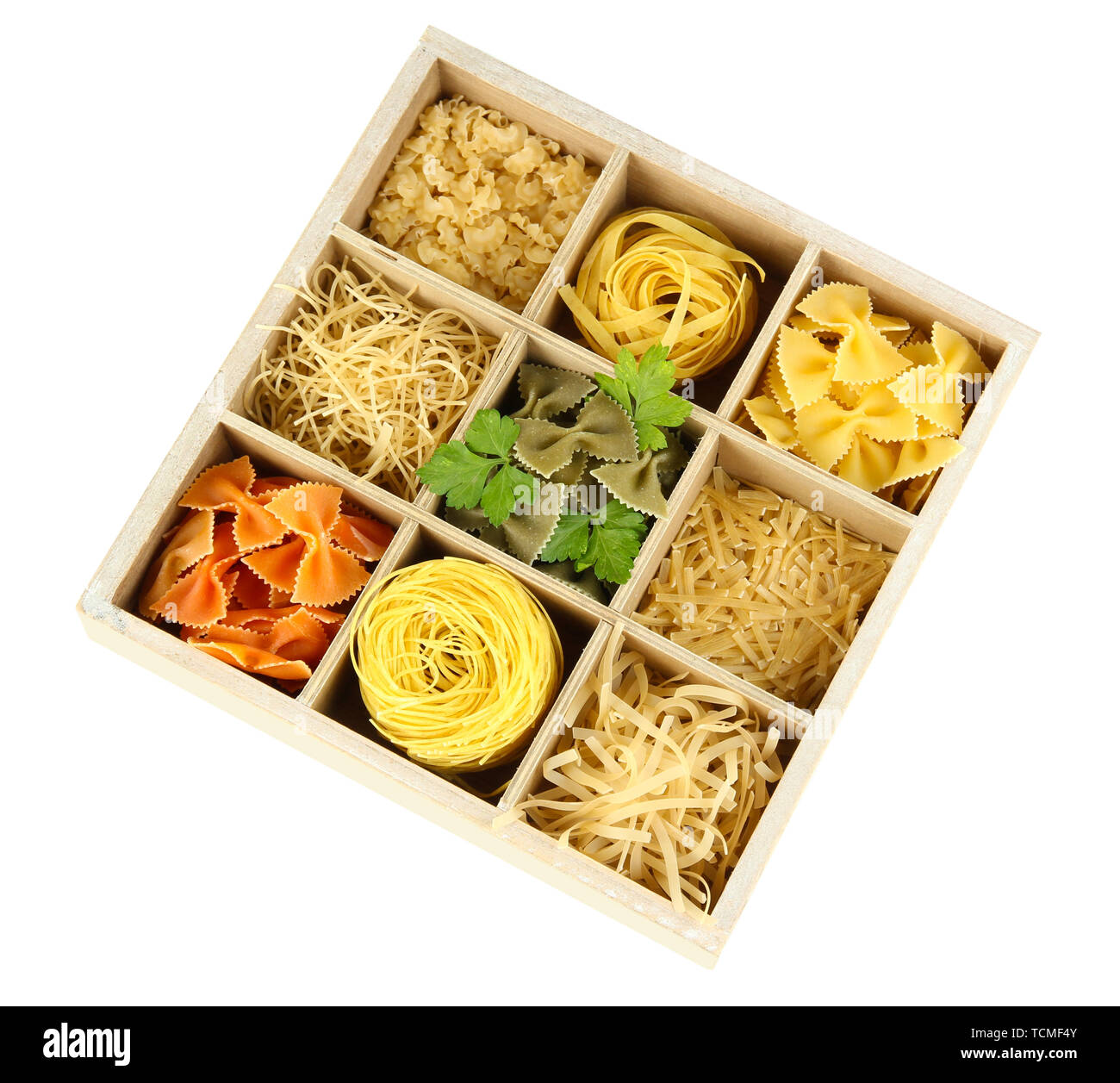 Nine types of pasta in wooden box sections close-up isolated on white ...