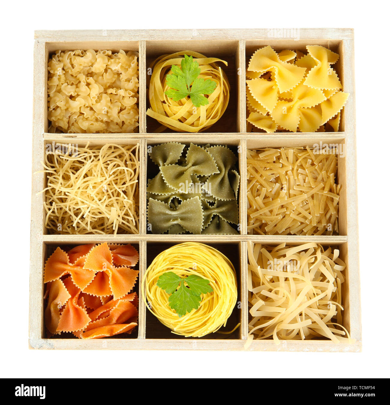 Nine types of pasta in wooden box sections close-up isolated on white ...