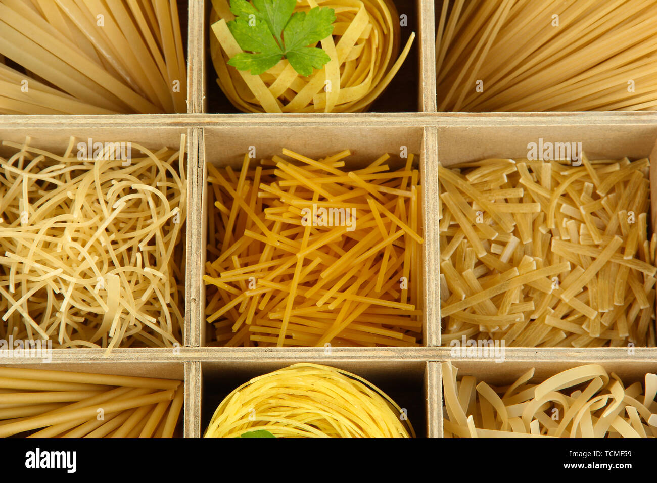 Nine types of pasta in wooden box sections close-up Stock Photo - Alamy