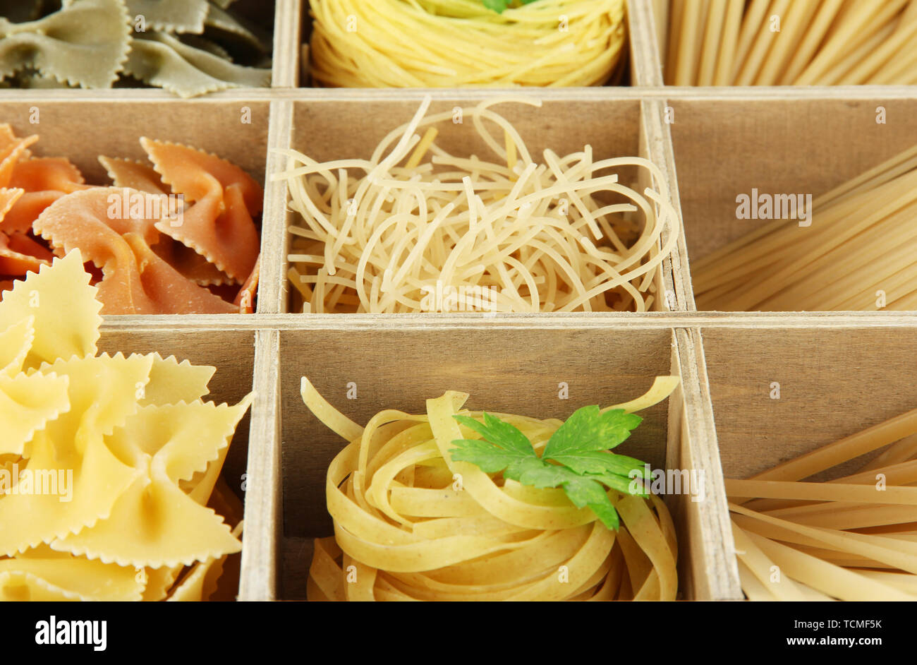 Nine types of pasta in wooden box sections close-up Stock Photo - Alamy