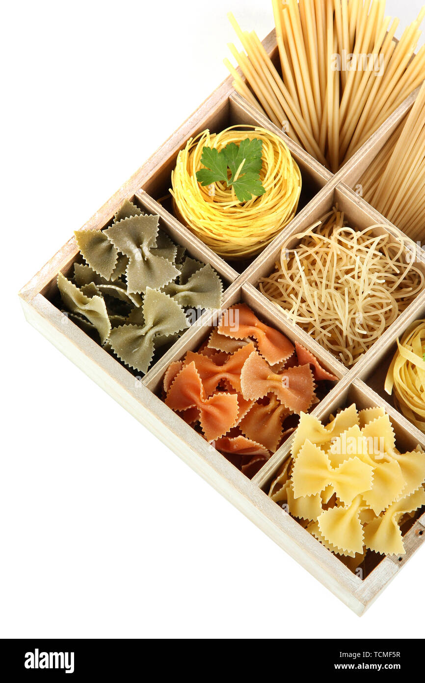 Nine types of pasta in wooden box sections close-up isolated on white ...