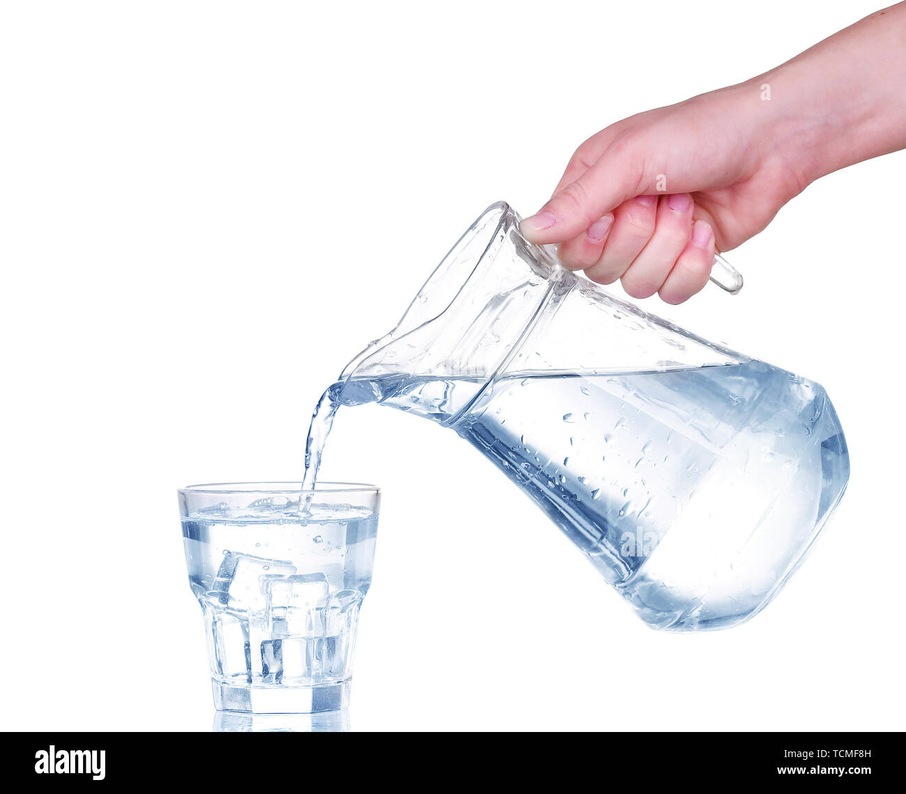 Pouring water from glass pitcher on white background Stock Photo - Alamy