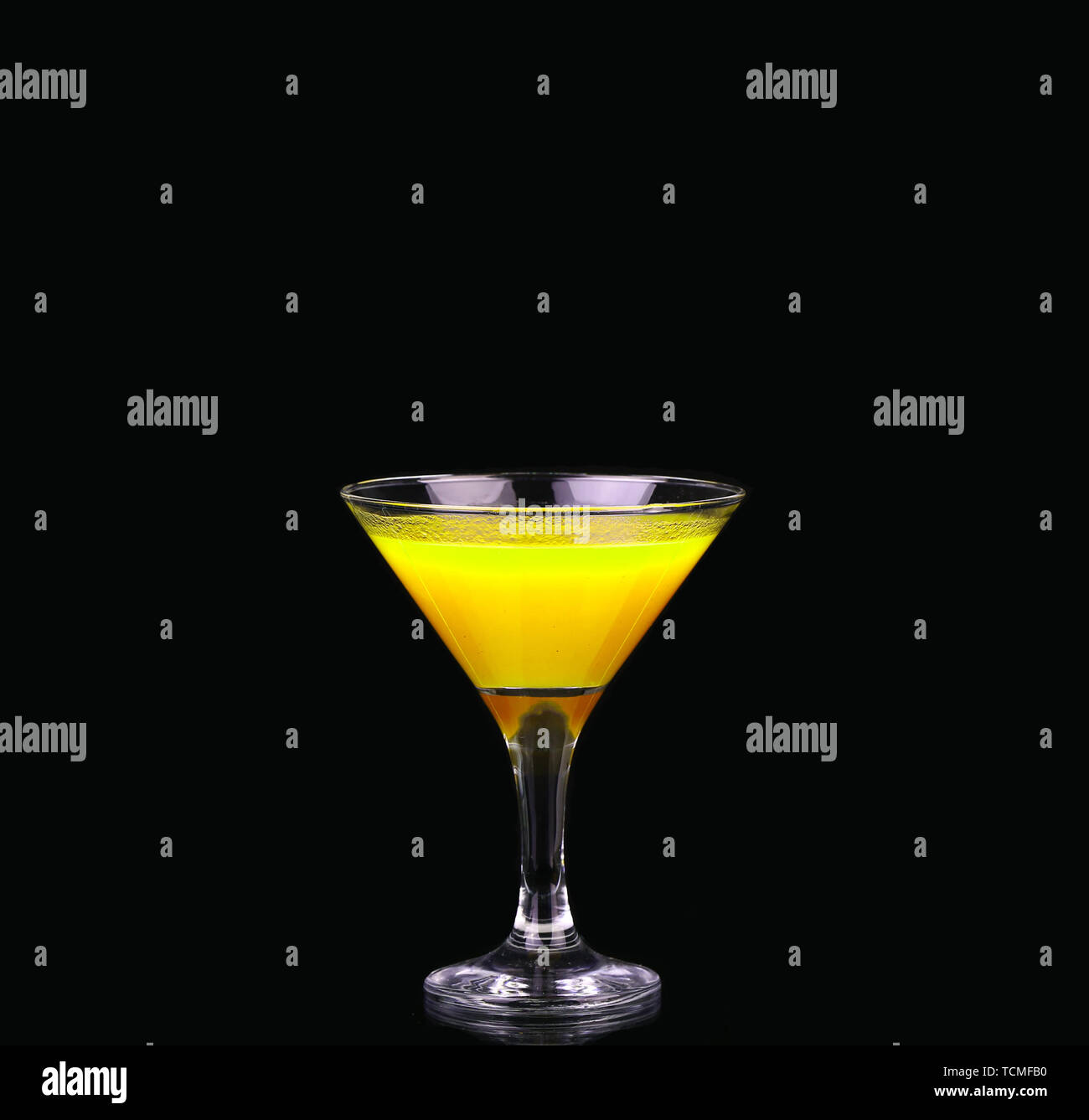 Yellow cocktail in martini glass isolated on black background Stock ...
