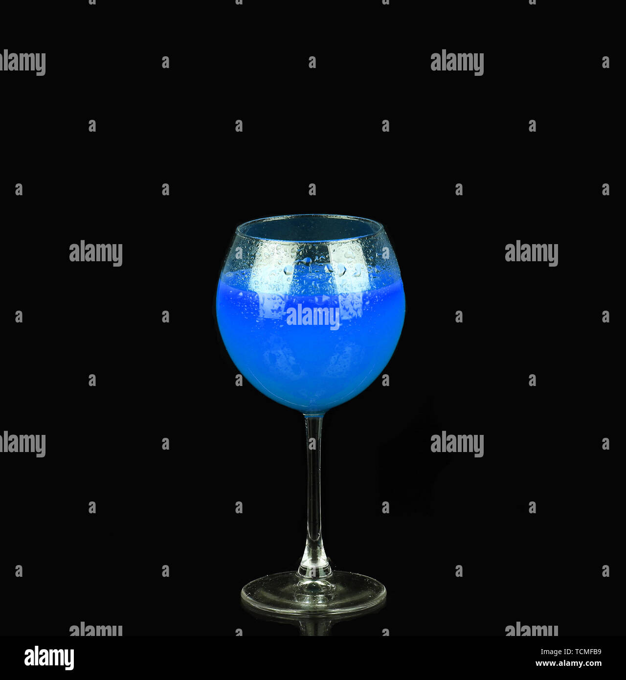 Blue alcoholic cocktail on the black background Stock Photo - Alamy