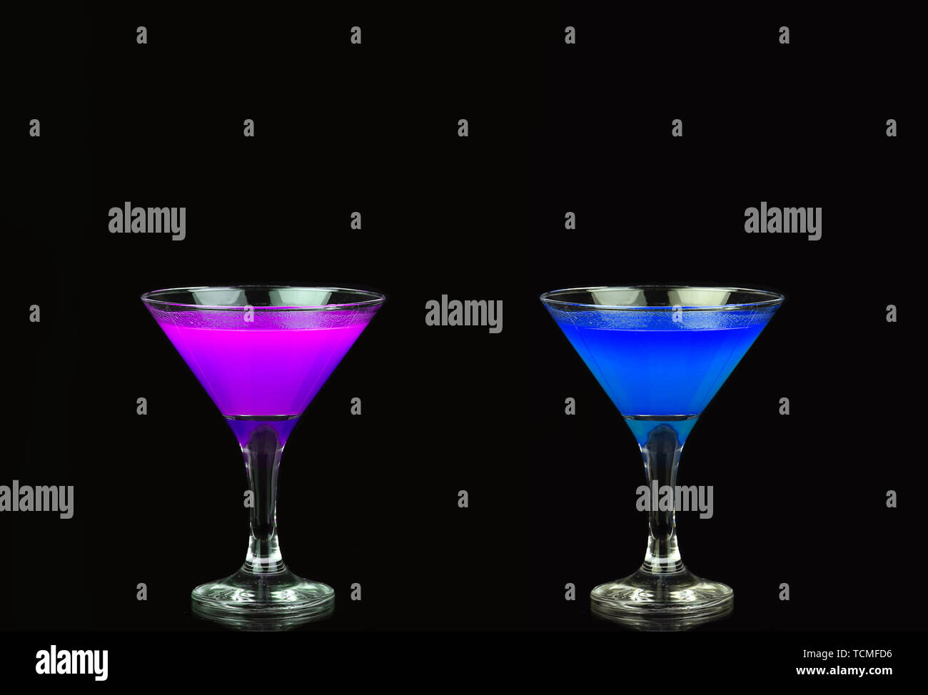 Cosmopolitan cocktail in a nice purple and blue in front of a black ...