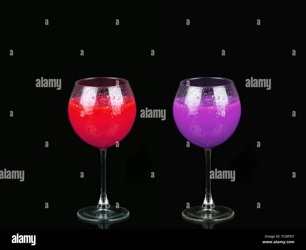 Cosmopolitan cocktail in nice red and purple colors in front of a black ...