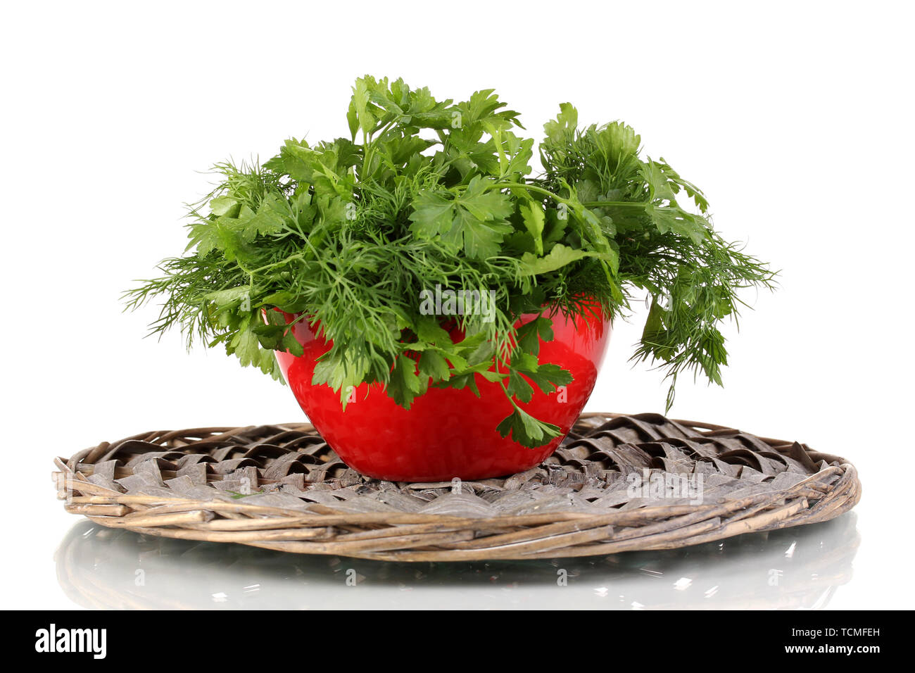 Red pot with parsley and dill on wicker cradle isolated on white Stock ...