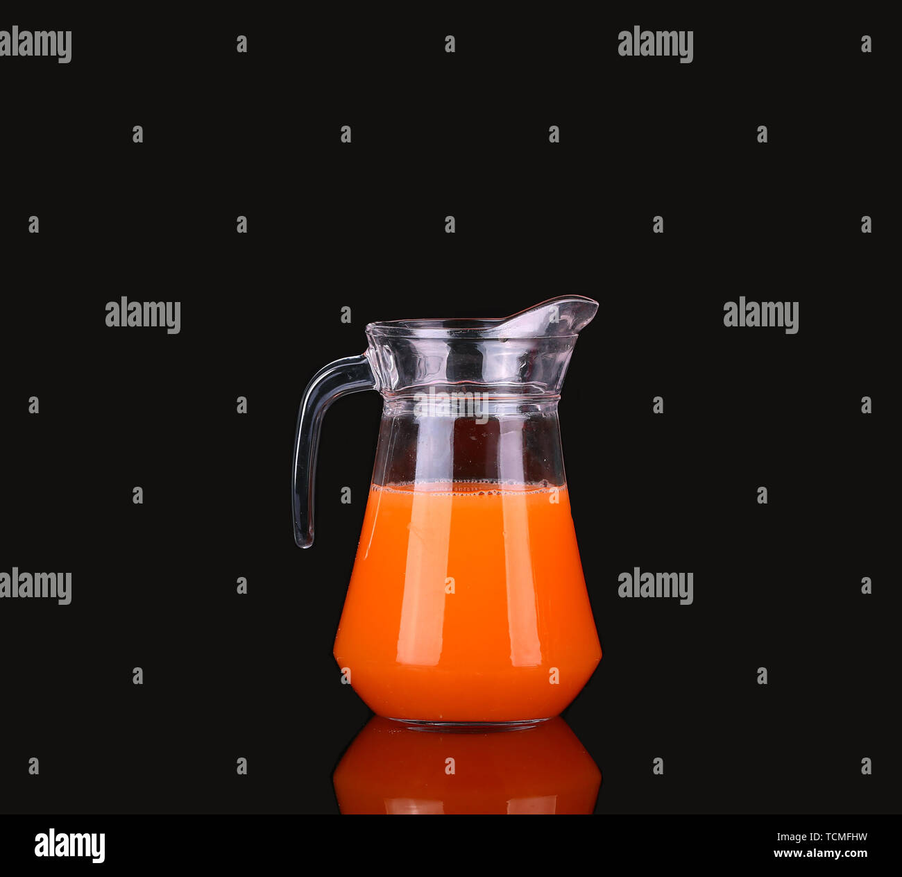 grapefruit juice in a jug on black Stock Photo - Alamy