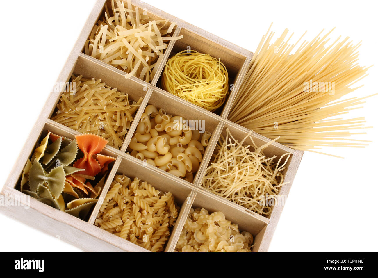 Nine types of pasta in wooden box sections isolated on white Stock ...