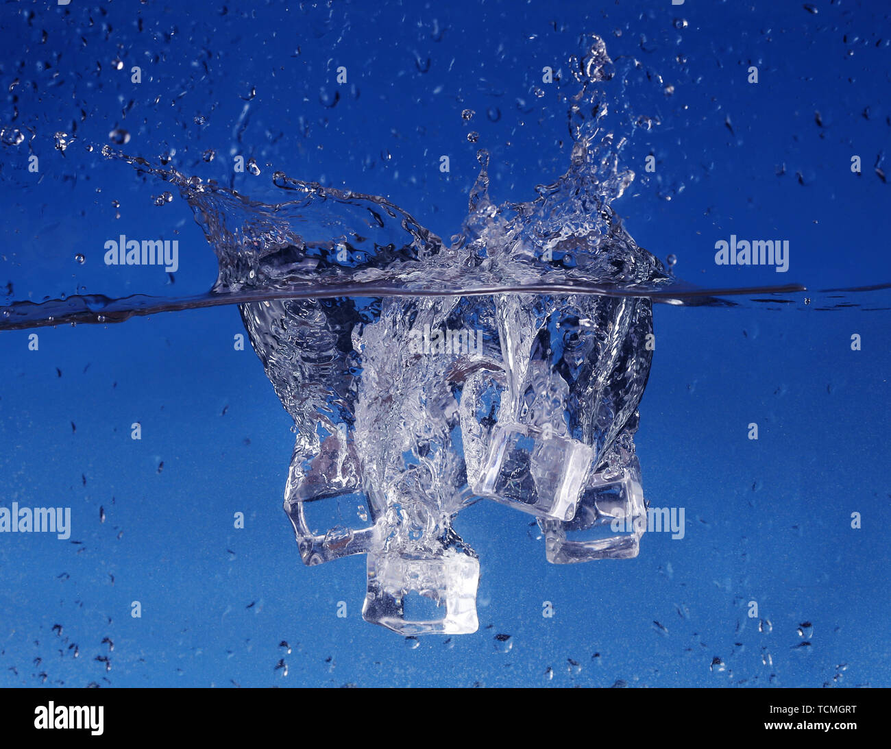 Ice cubes splashing into water, close-up Stock Photo - Alamy