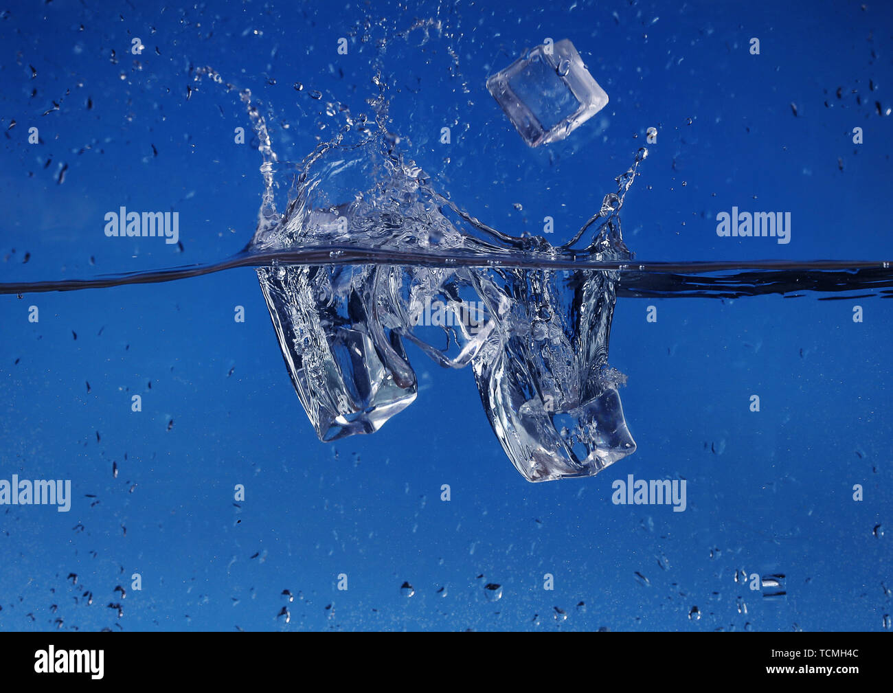 Ice cubes splashing into water, close-up Stock Photo - Alamy