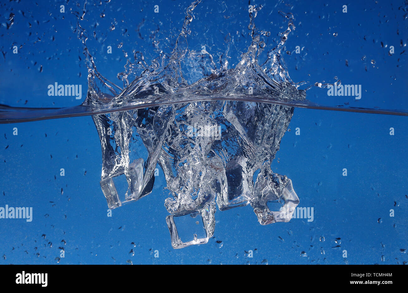 Ice cubes splashing into water, close-up Stock Photo - Alamy