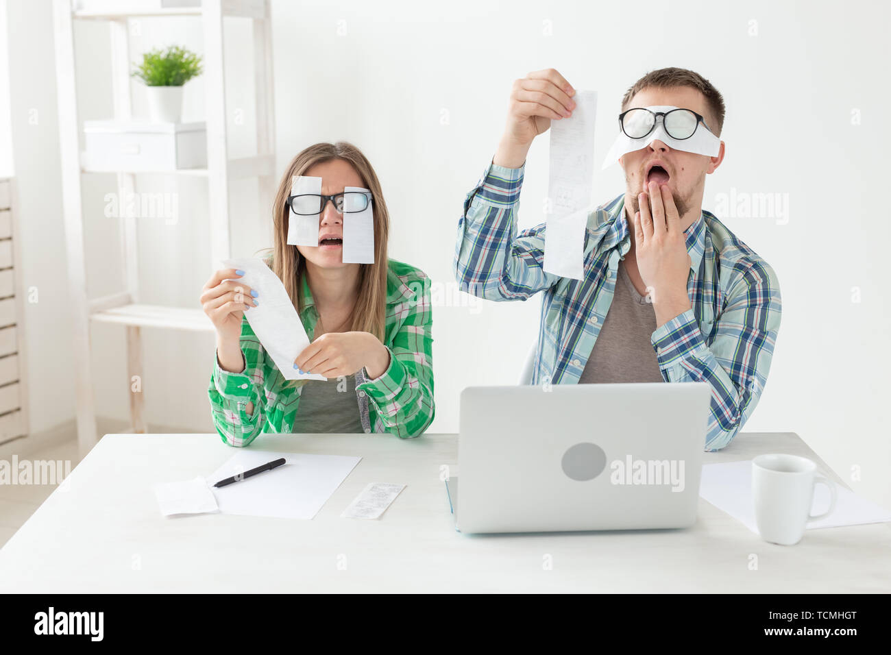 Finance and funny concept - Husband and wife in shock from numerous of ...