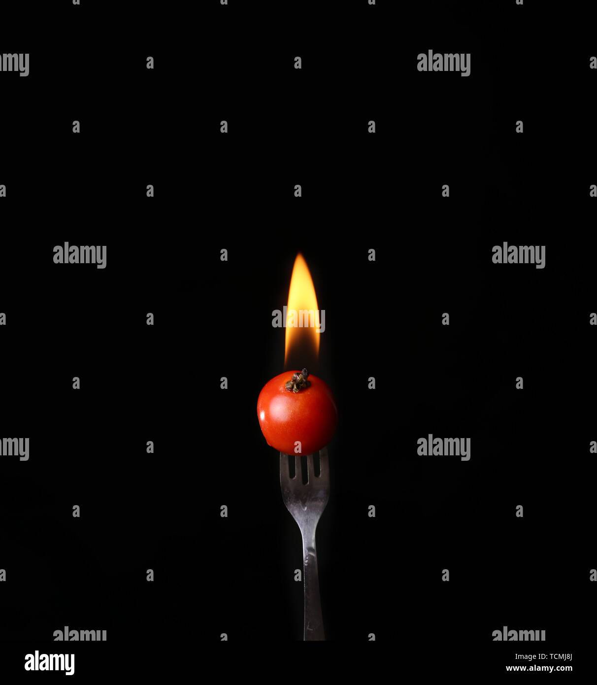 Tomato on fire with blue flames isolated on black background Stock ...