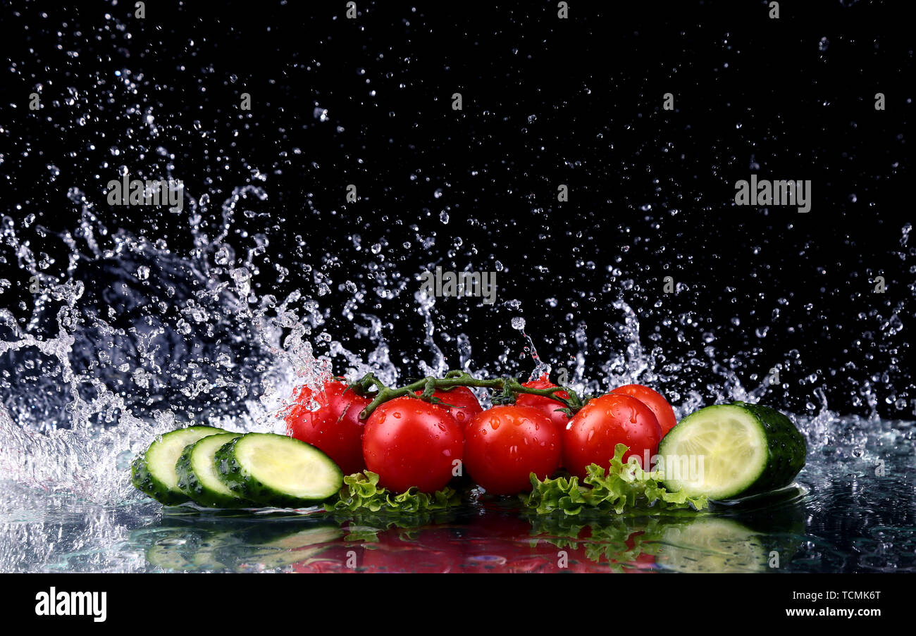 Studio shot with freeze motion of cherry tomatoes and slices of ...