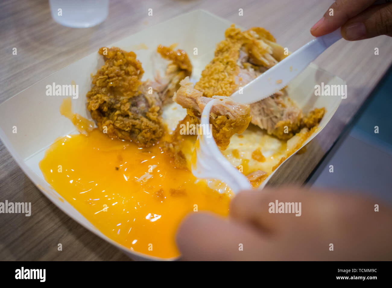 Asian women eating fried chicken, focus woman hand hold fried chicken ...