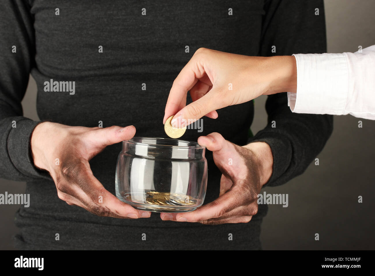 helping the homeless, on black background close-up Stock Photo - Alamy
