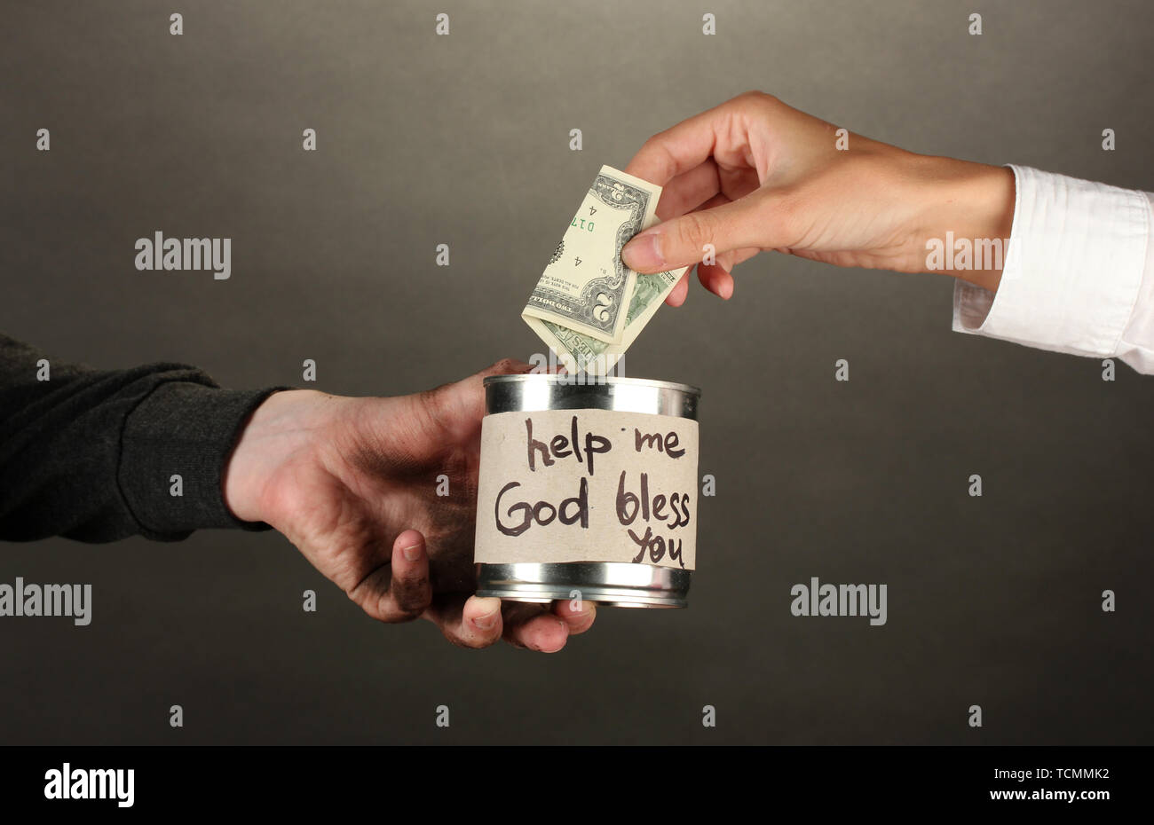 helping the homeless, on black background close-up Stock Photo - Alamy