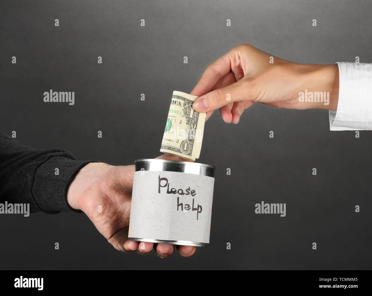helping the homeless, on black background close-up Stock Photo - Alamy
