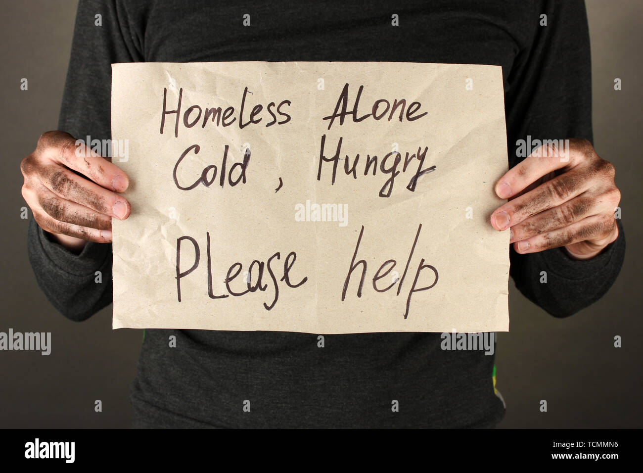 homeless man asks for help, on black background close-up Stock Photo ...