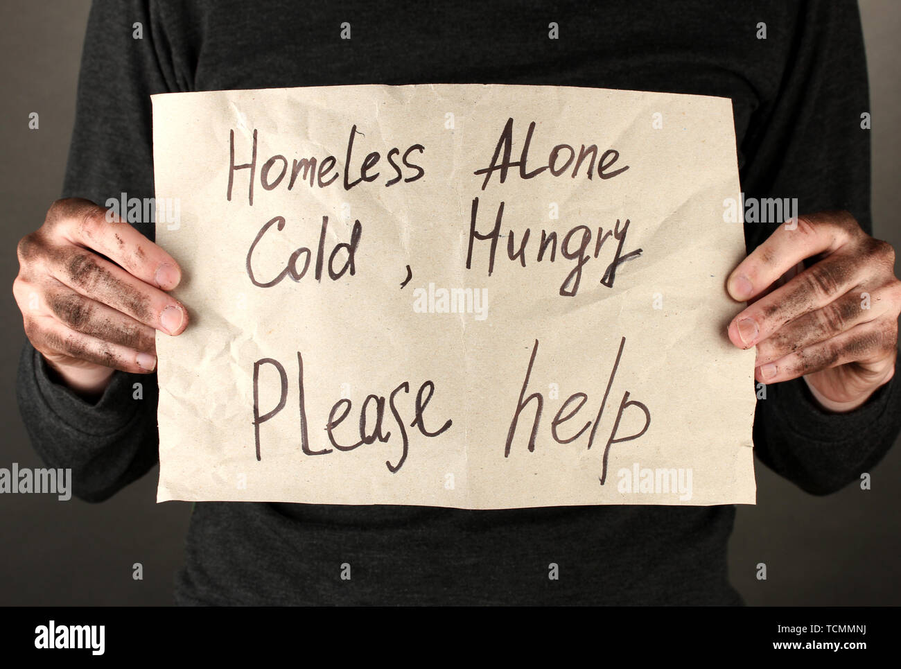 homeless man asks for help, on black background close-up Stock Photo ...