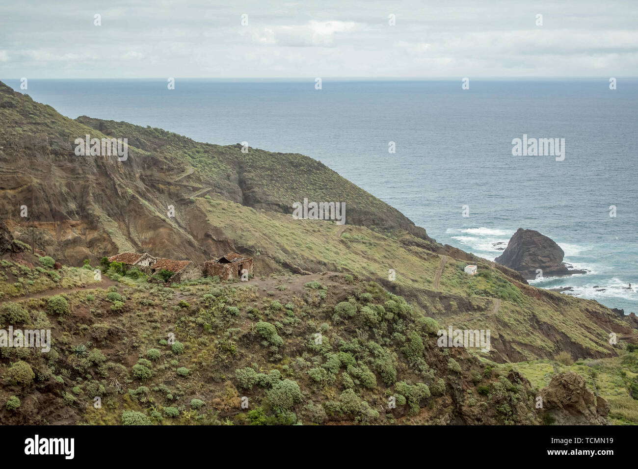Steep high lava rock cliffs on on the east of Tenerife. Solitary rocks ...