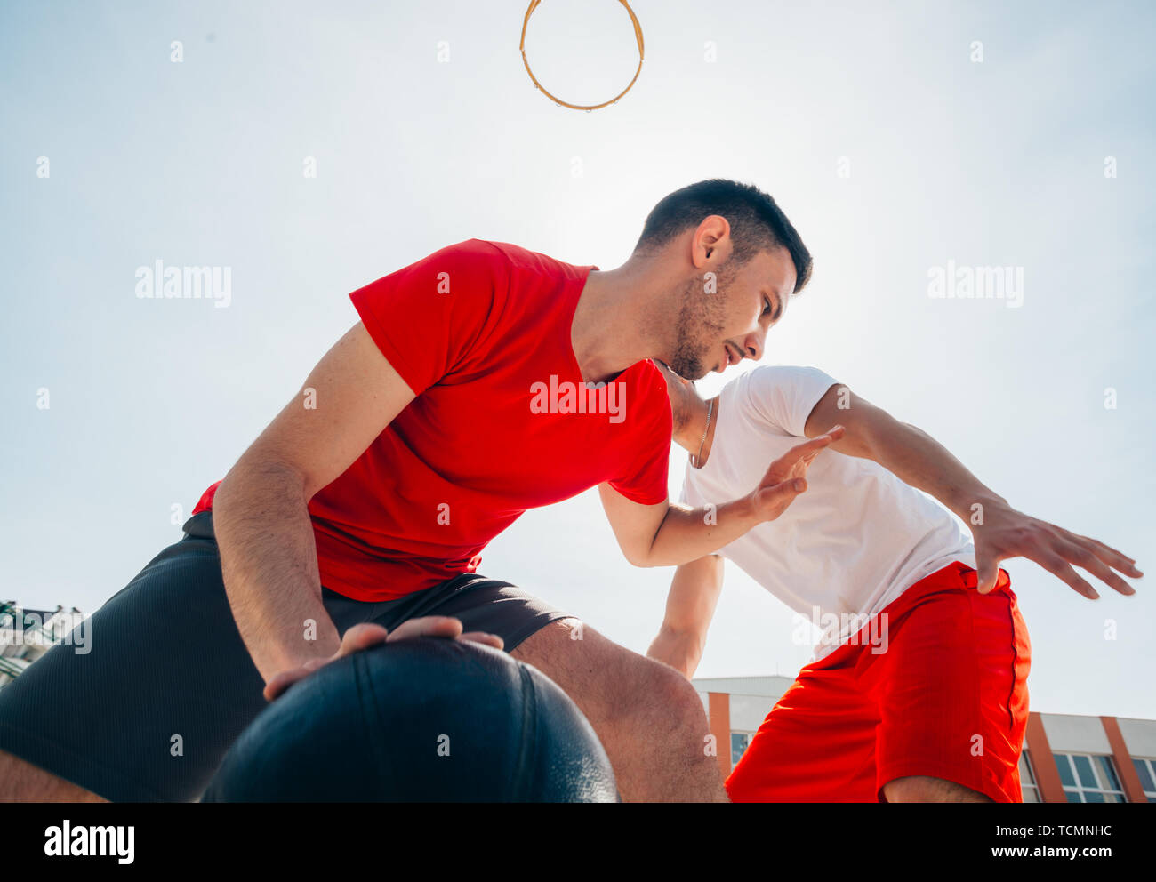 Close up portrait of two basketball players while the push each other ...