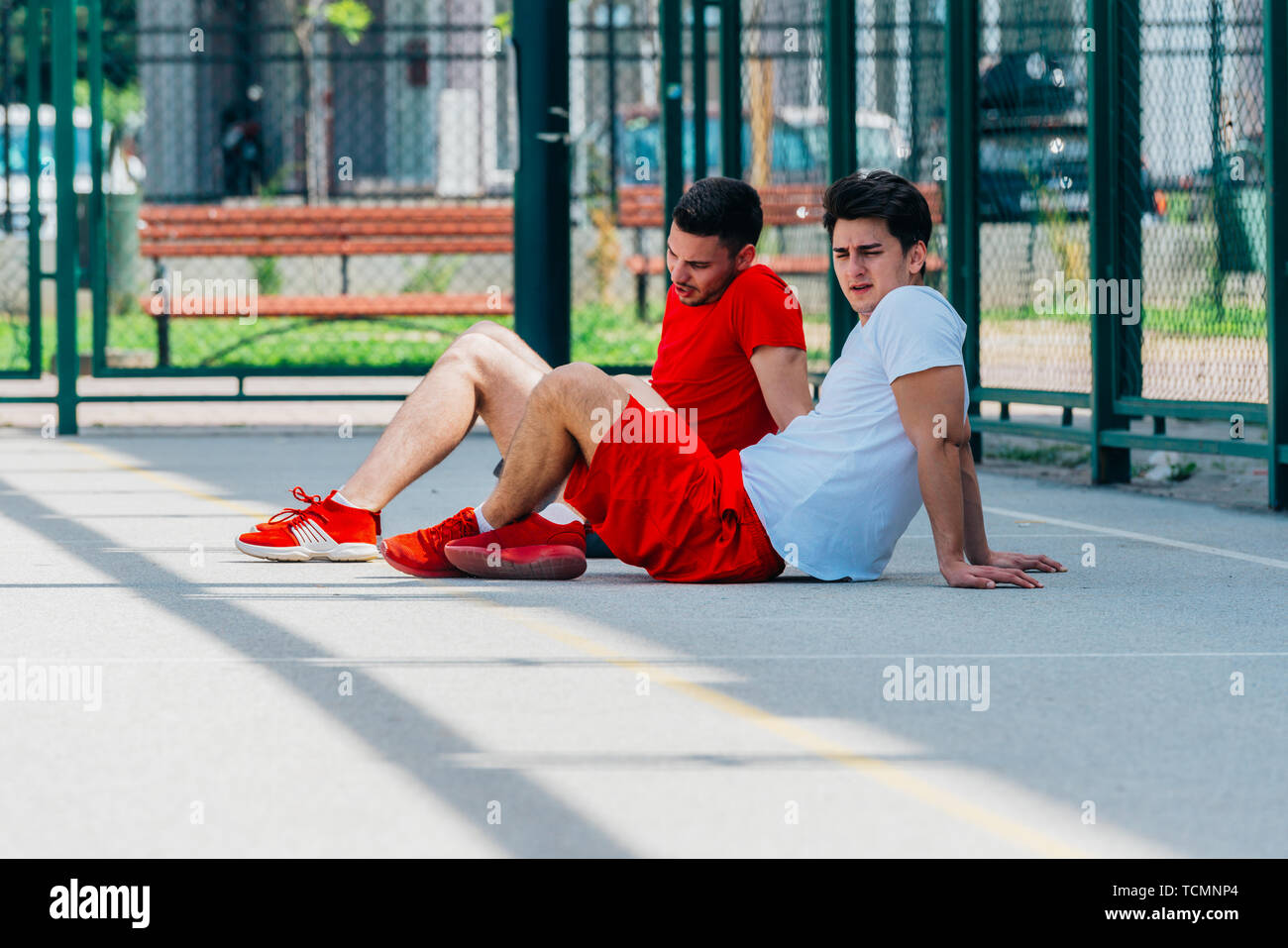 Two friends after a long hard basketball game have some rest on the ...