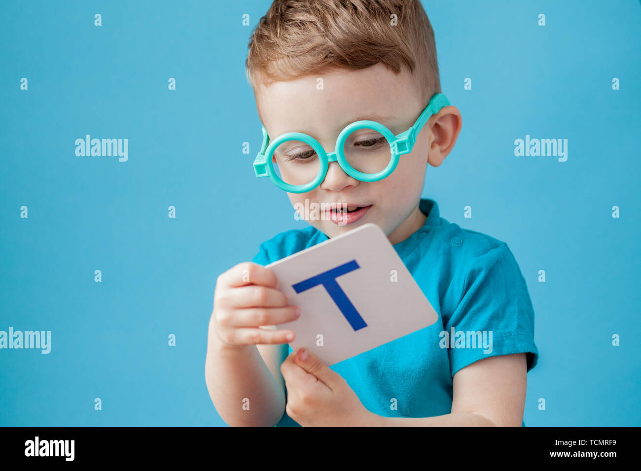 Cute little boy with letter on background. Child learn letters ...