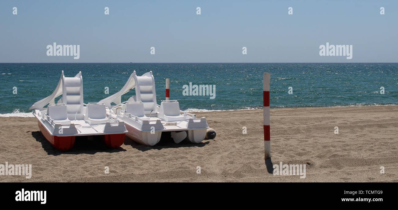 Pedal boats with slide for sea ride on the sea shore Stock Photo - Alamy