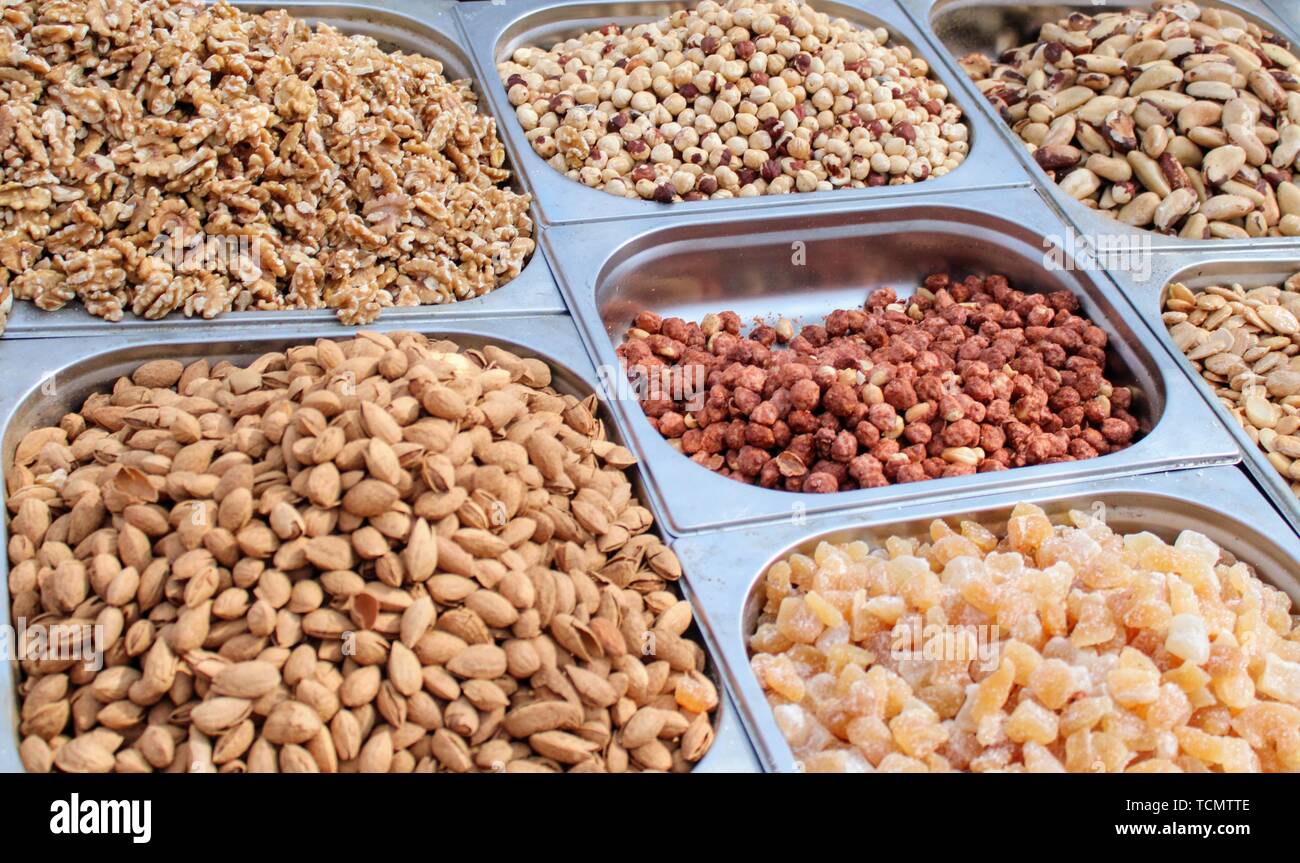 Variety of nuts in containers exposed in the market Stock Photo - Alamy