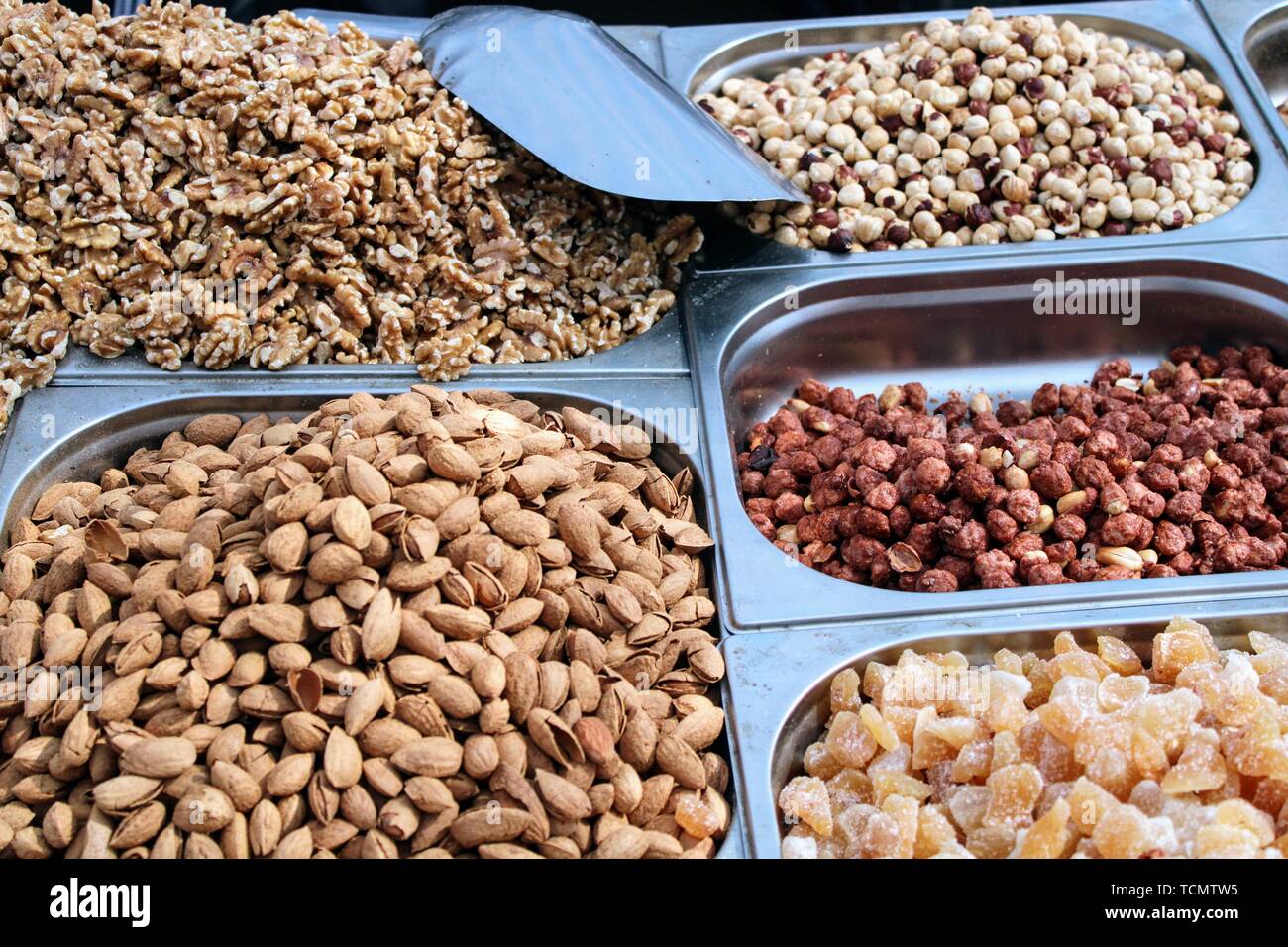 Variety of nuts in containers exposed in the market Stock Photo - Alamy