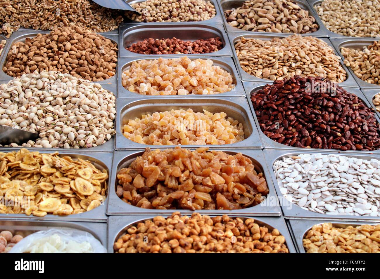 Variety of nuts in containers exposed in the market Stock Photo - Alamy