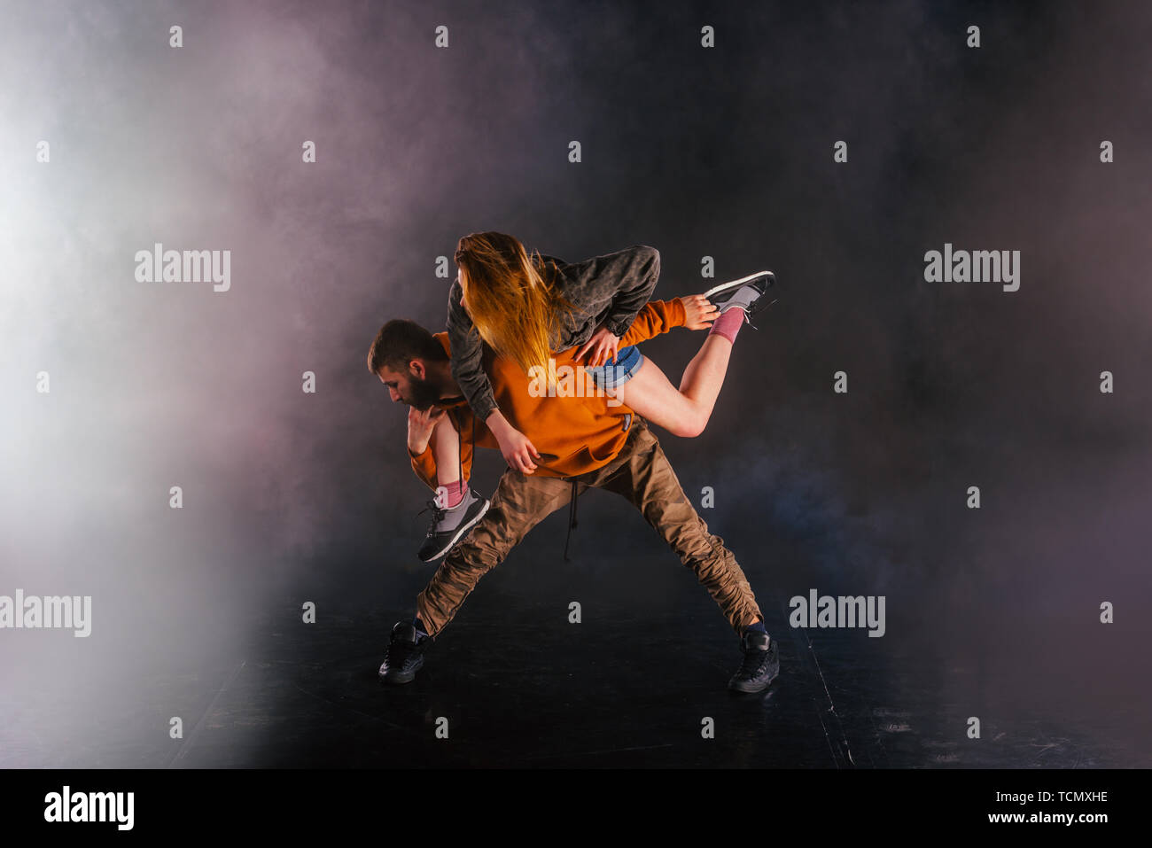 Strong male dancer and an elegant female dancer perform an exotic and ...