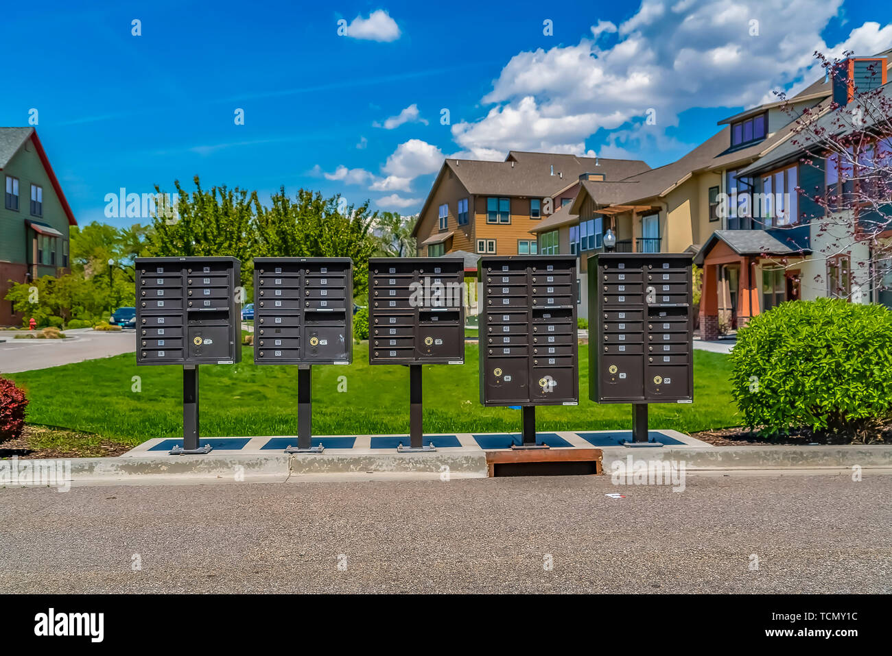 Row of cluster mailboxes with numbered compartments on the sidewalk ...