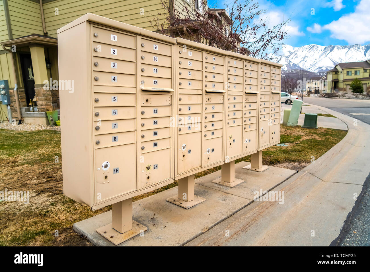 Residential mailboxes with numbered compartments on the side of a road ...