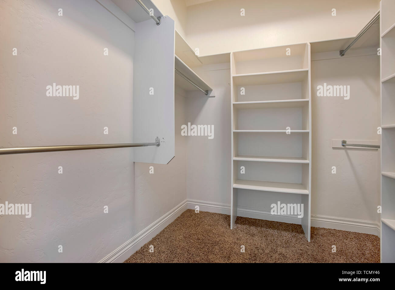 Interior of a walk in closet with shelves and shiny garment rods Stock ...