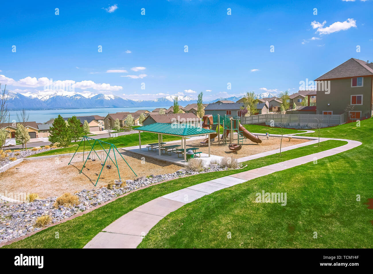 Houses and park with playground and picnic area on a neighborhood near ...
