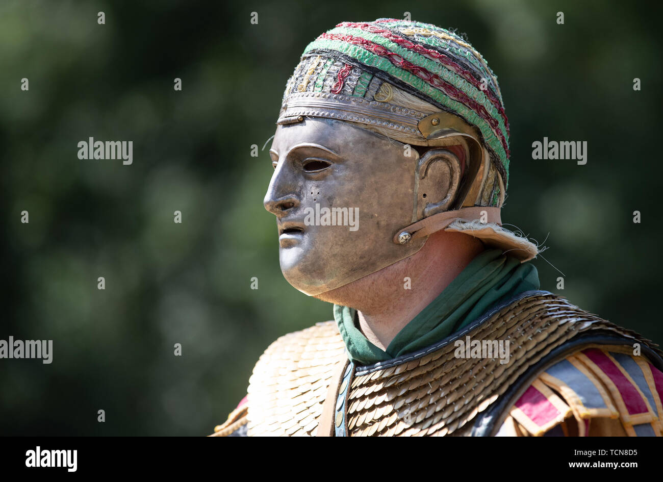 Bramsche, Germany. 09th June, 2019. A Roman actor rides with a mask at ...