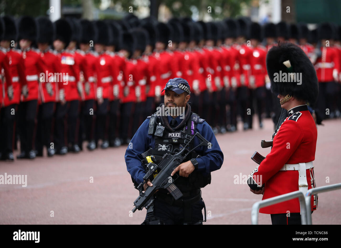 An armed police officer patrols along The Mall at the Trooping of the ...