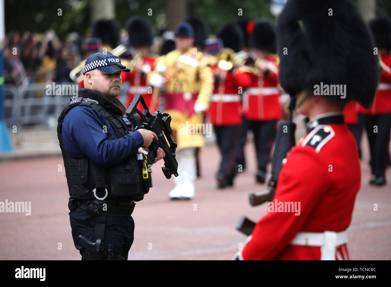 An armed police officer on patrol on The Mall at the Trooping of the ...