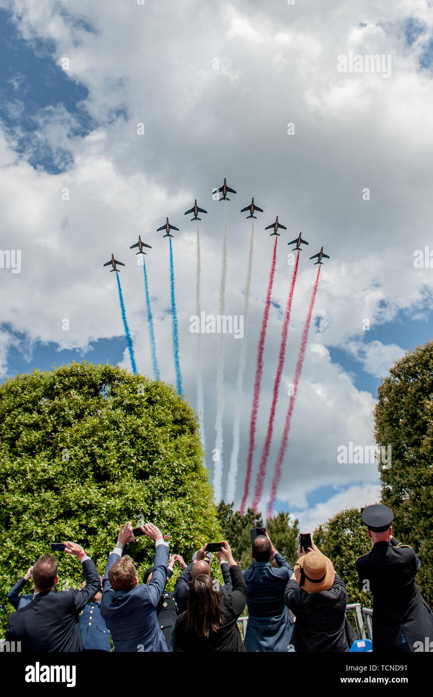 Spectators watch as French aircraft conduct a fly-over at the 75th ...