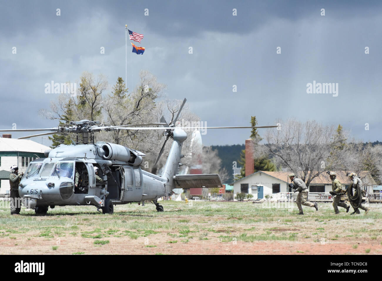 Members of 7th Special Forces Group load an MH-60S Seahawk, flown by ...