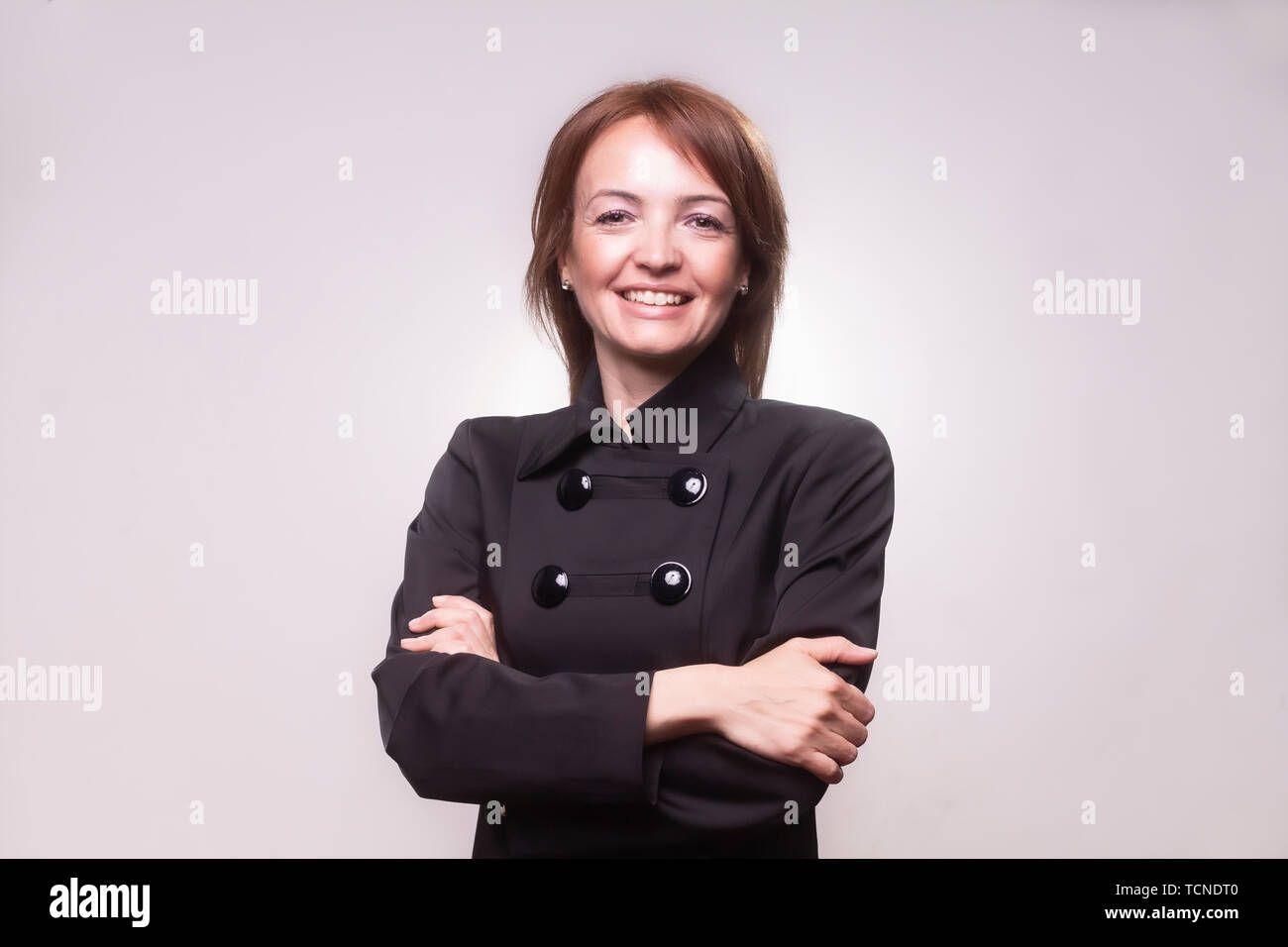 one happy mature woman portrait, 40-49 years old, with her arms crossed ...