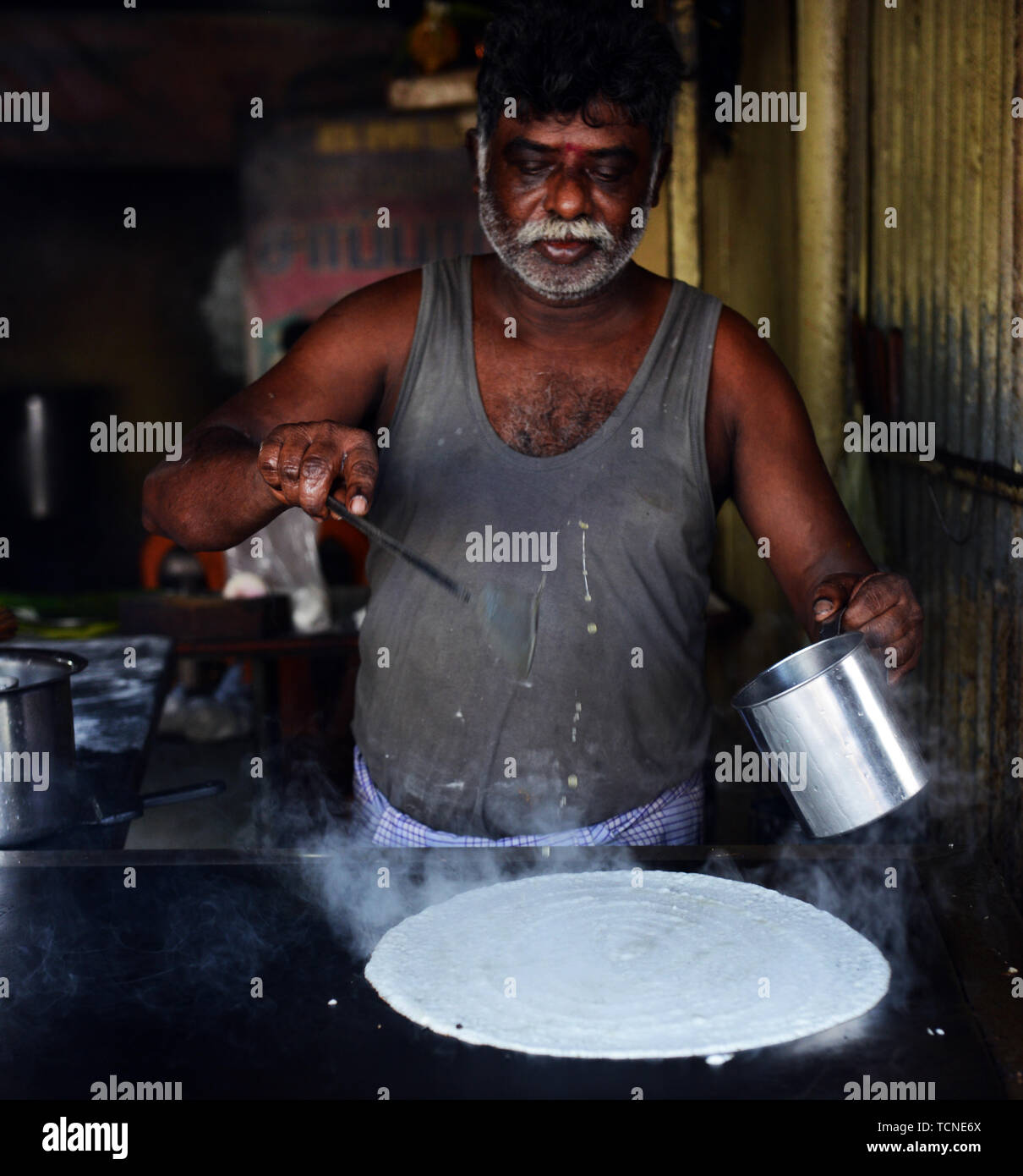 A Tamil cook preparing a Dosa Stock Photo - Alamy