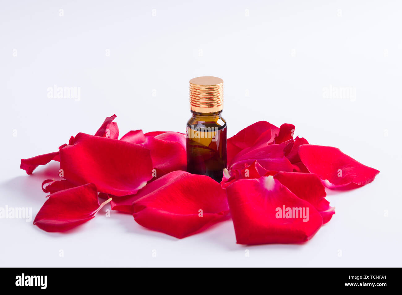 Red roses and essential oils Stock Photo - Alamy