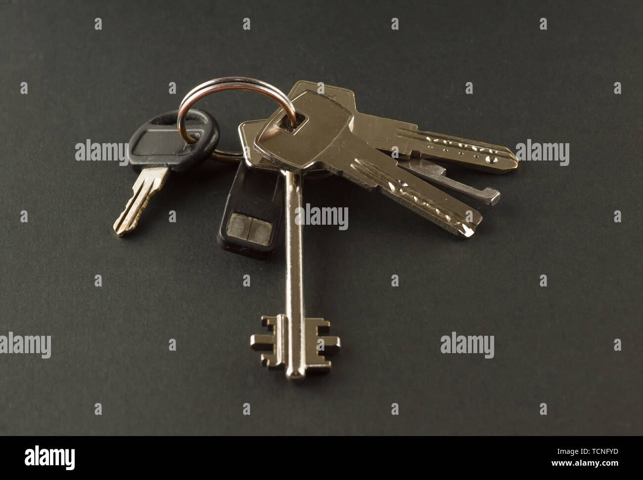 big bunch of keys to the apartment on a black background Stock Photo ...