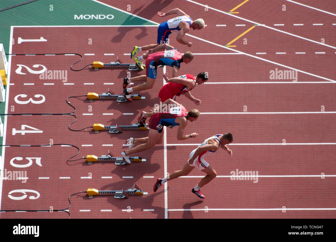 Male sprinters in starting blocks hi-res stock photography and images ...