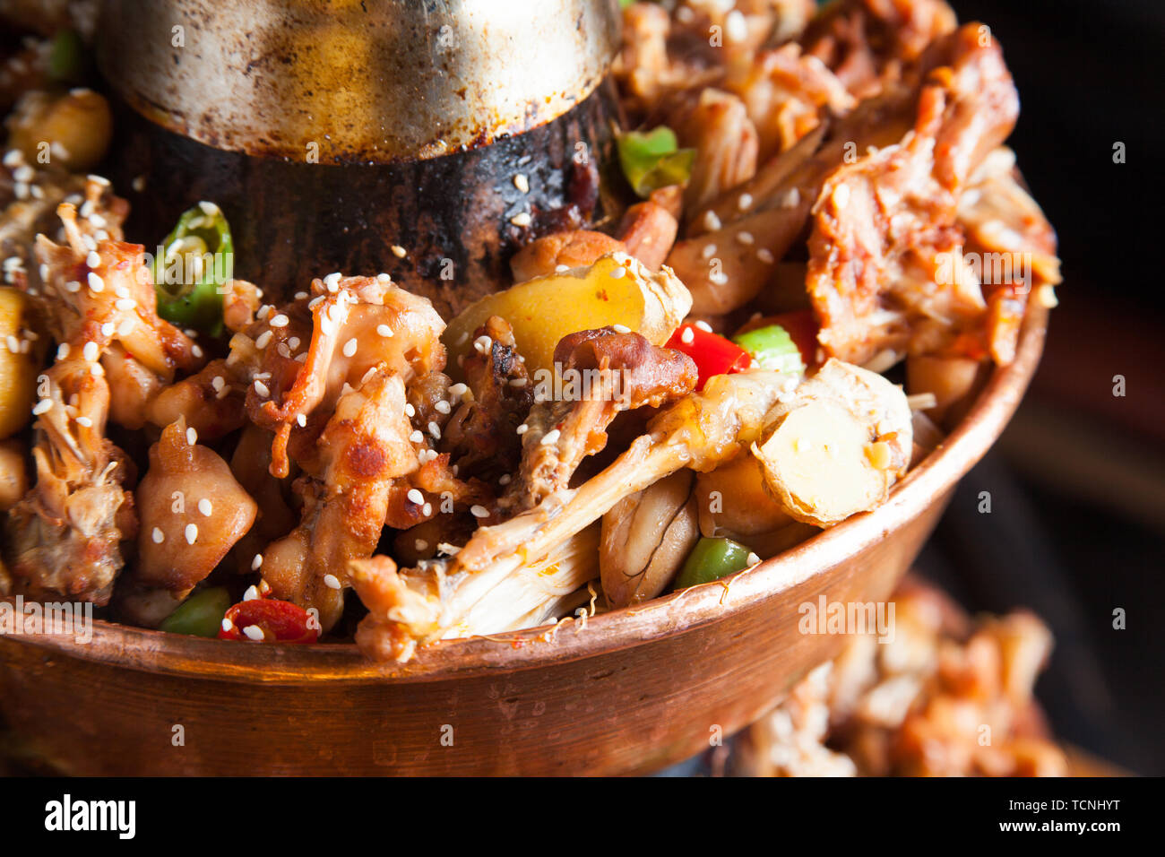 Charcoal fire frog pot field chicken meal Stock Photo - Alamy